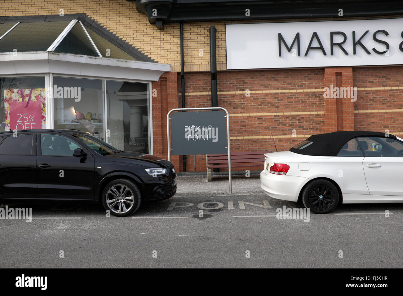 two cars parked in the pick up area at handforth dene shopping outlets ...