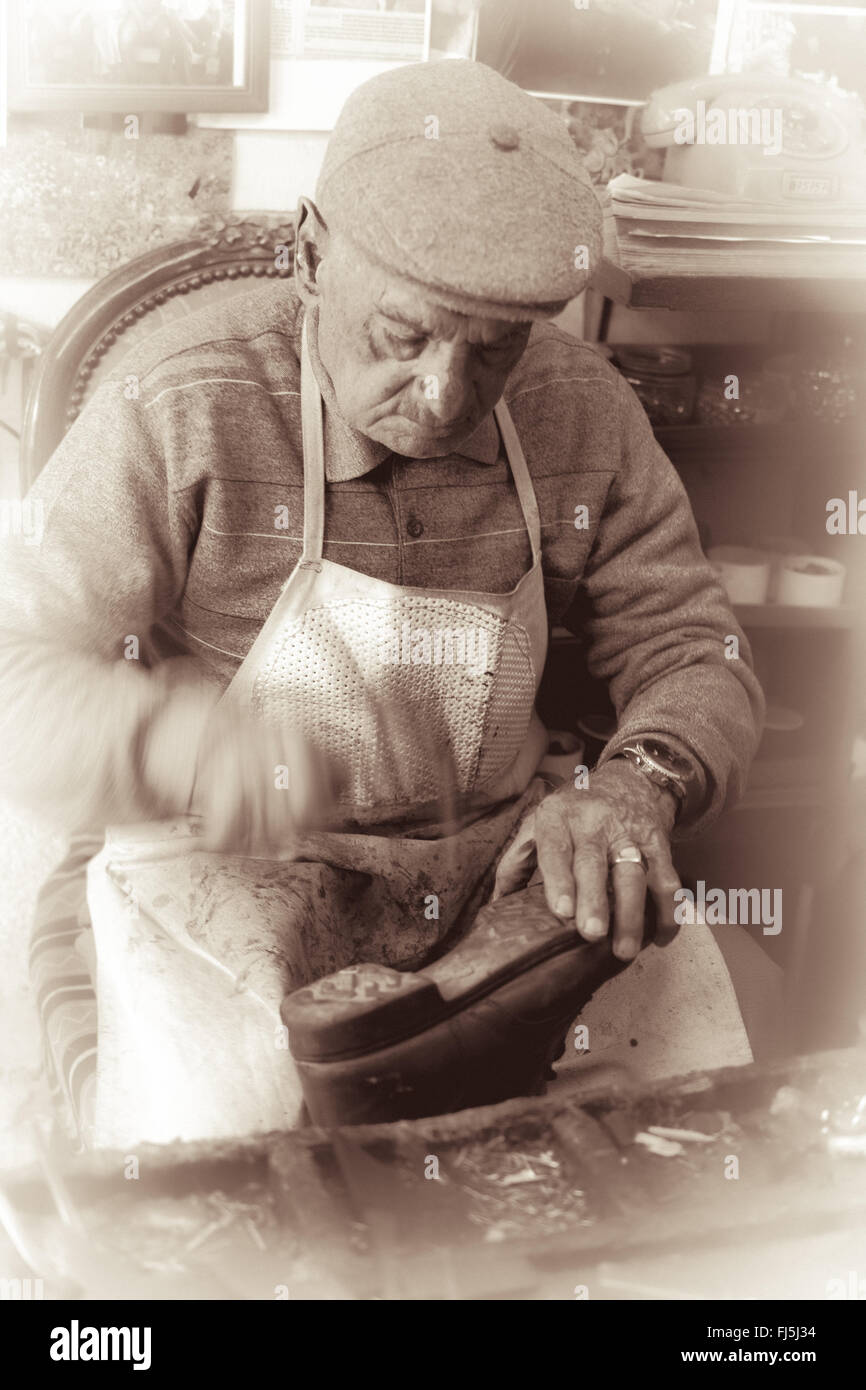 Cobbler at work practicing his craftsmanship with traditional tools in ...