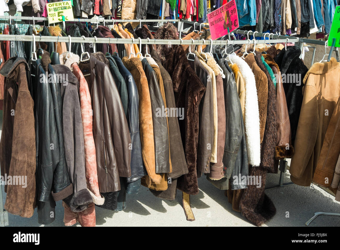 Second hand coats on a street market Stock Photo - Alamy