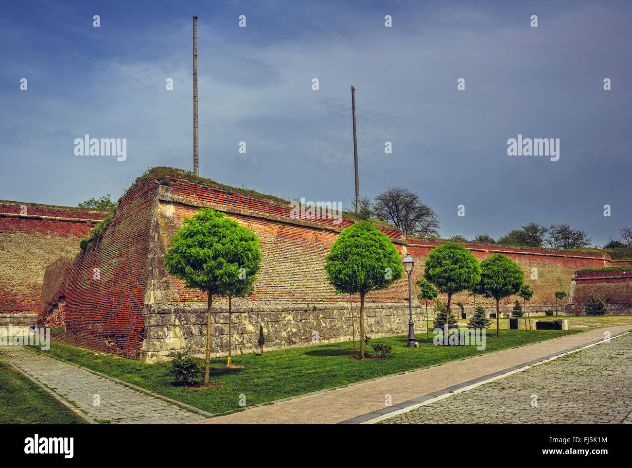 Picturesque scene with aged medieval defense fortification walls, green ...