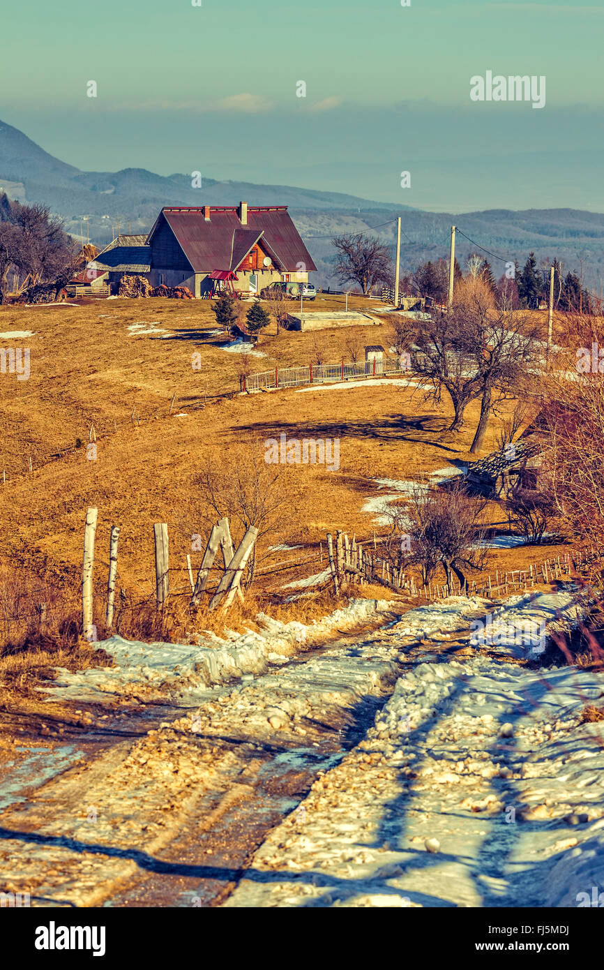 Peaceful Romanian rural scene with traditional farm and grassland ...
