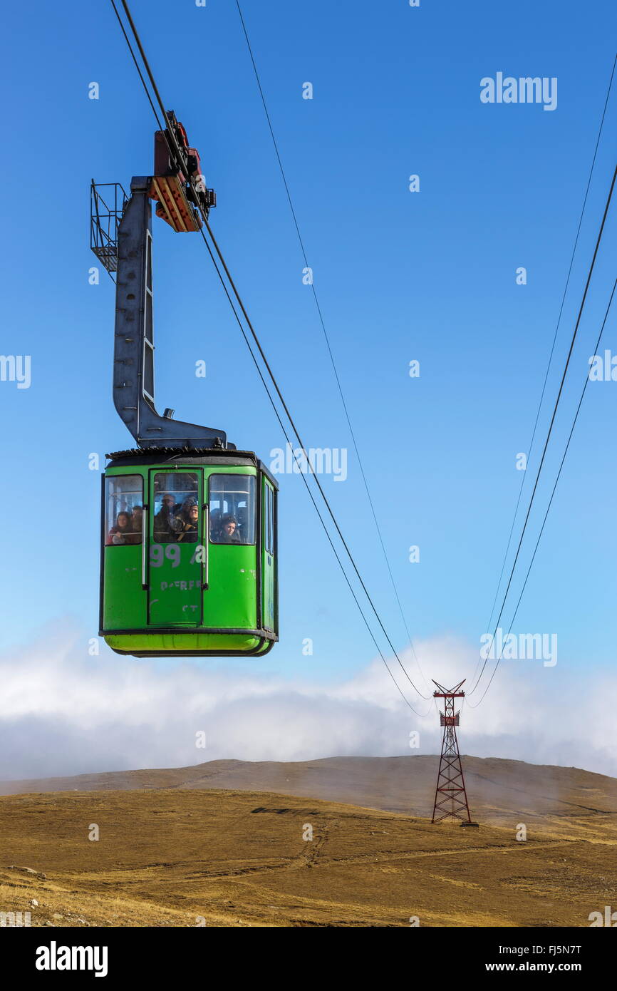 BUCEGI, ROMANIA - OCTOBER 10, 2015: Green cable car cabin transports ...
