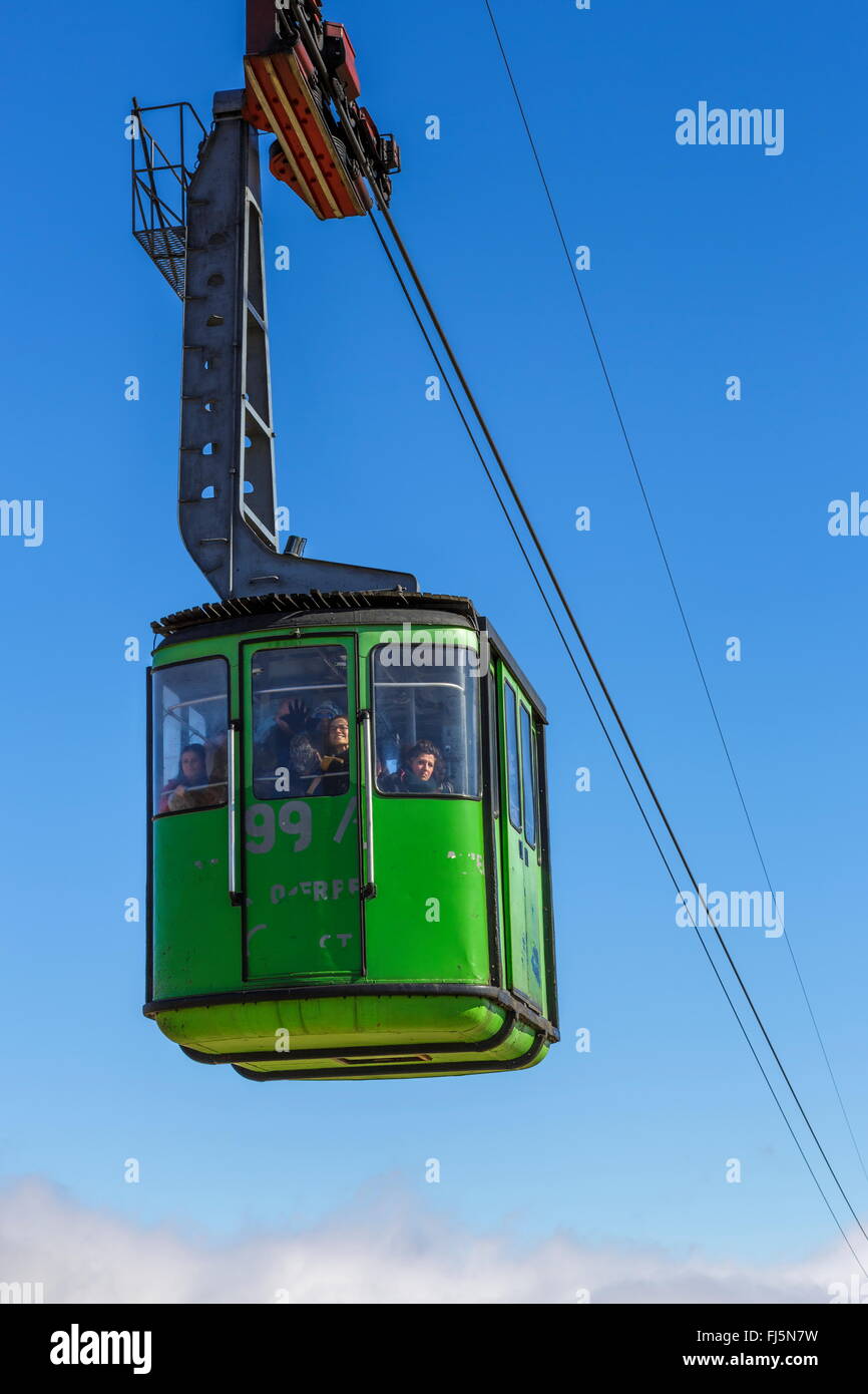 BUCEGI, ROMANIA - OCTOBER 10, 2015: Overhead green cable car cabin ...