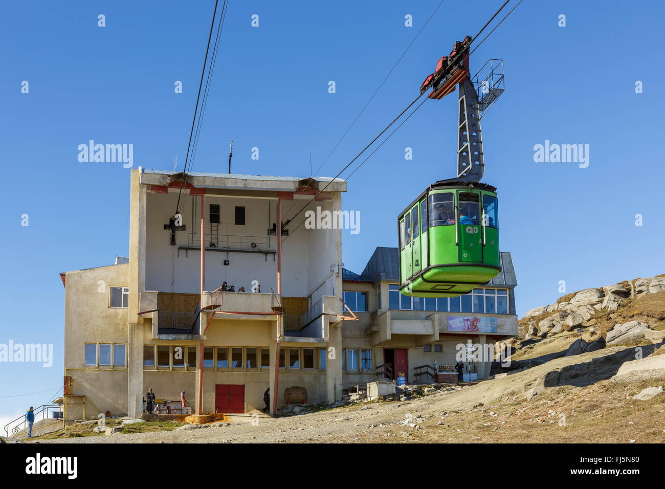 BUCEGI, ROMANIA - OCTOBER 10, 2015: Green cable car arrives at Babele ...