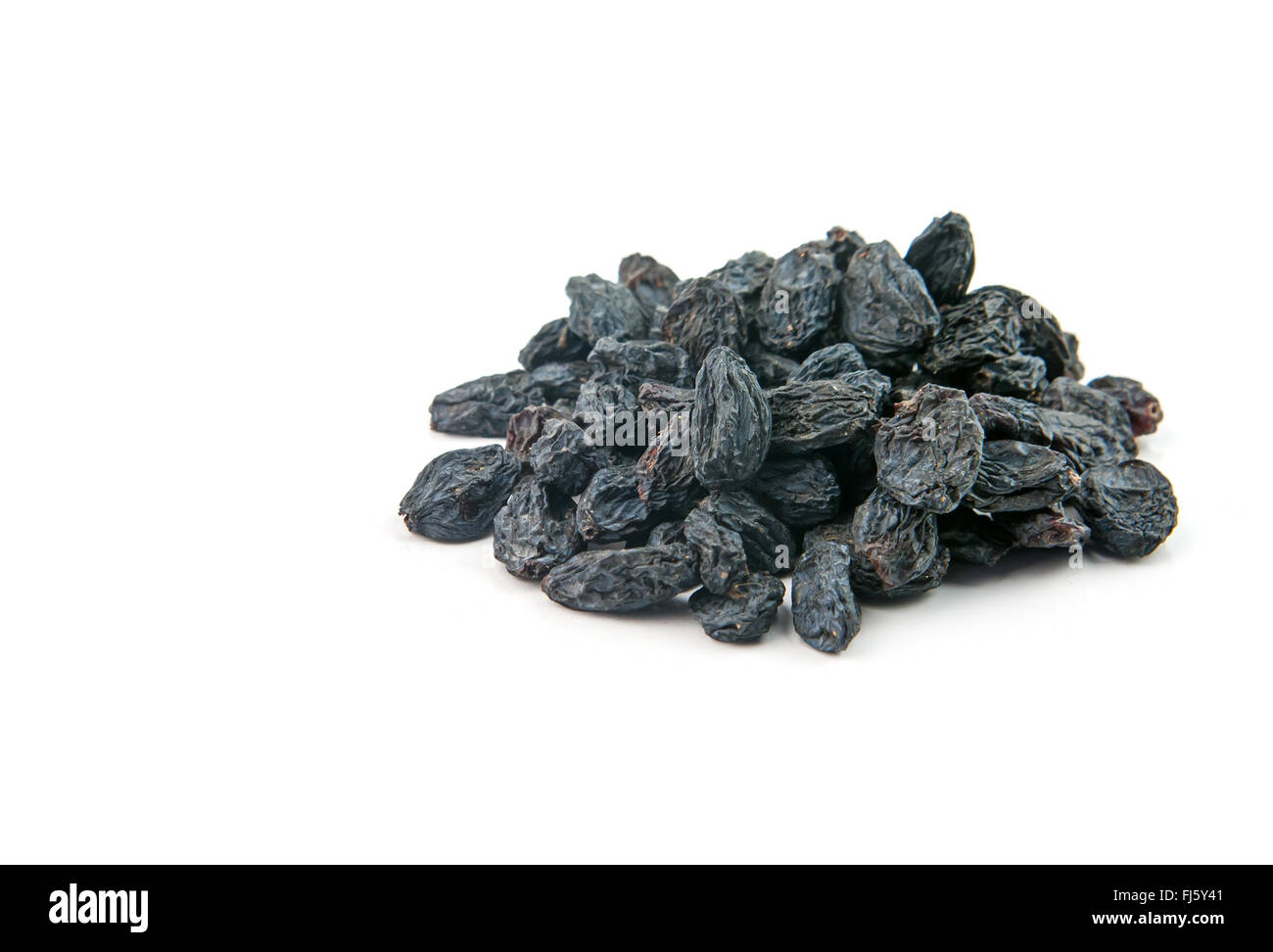 blue raisins on white background Stock Photo - Alamy