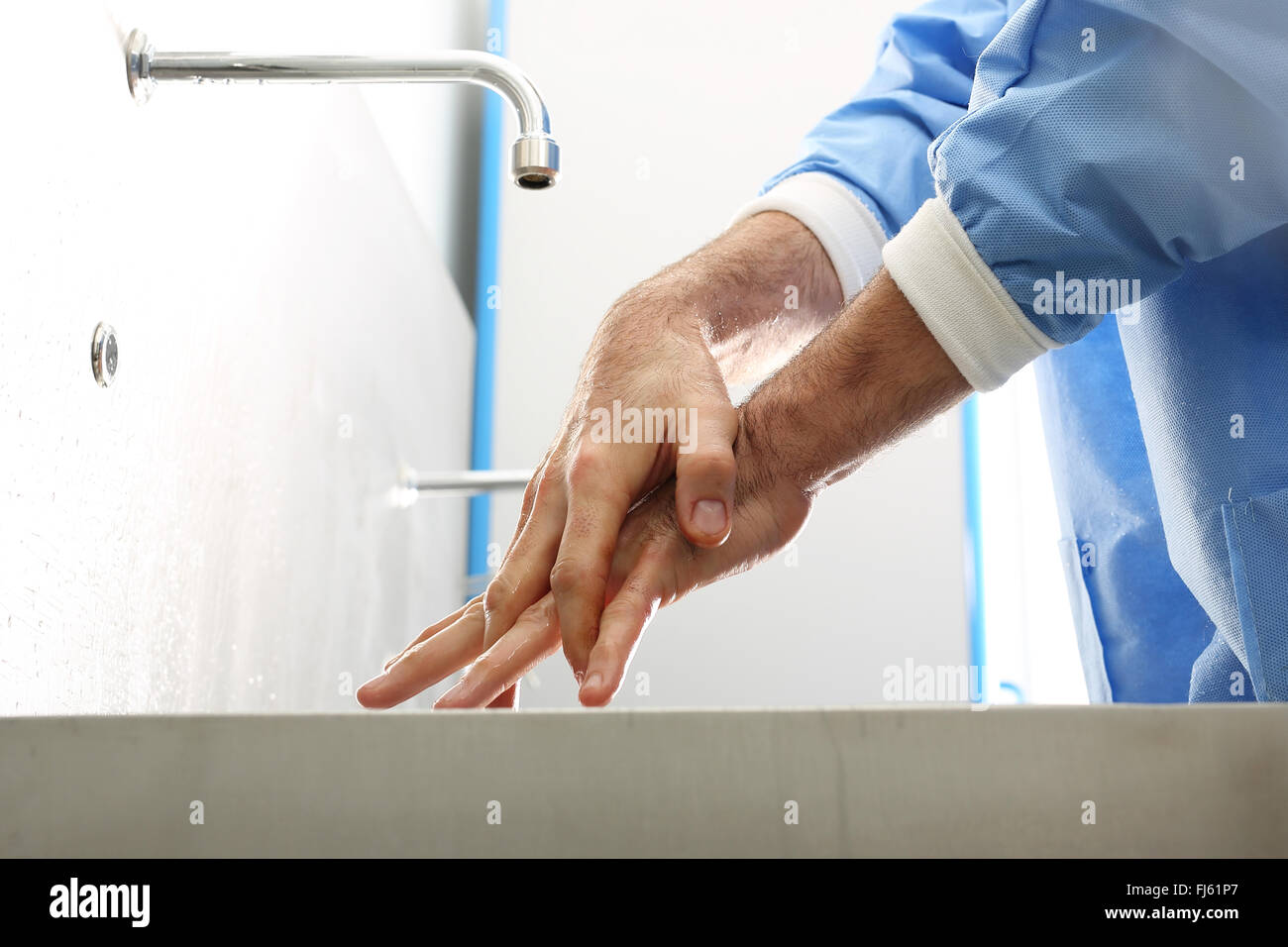Surgeon washing hands. The doctor washes his hands, disinfect their ...