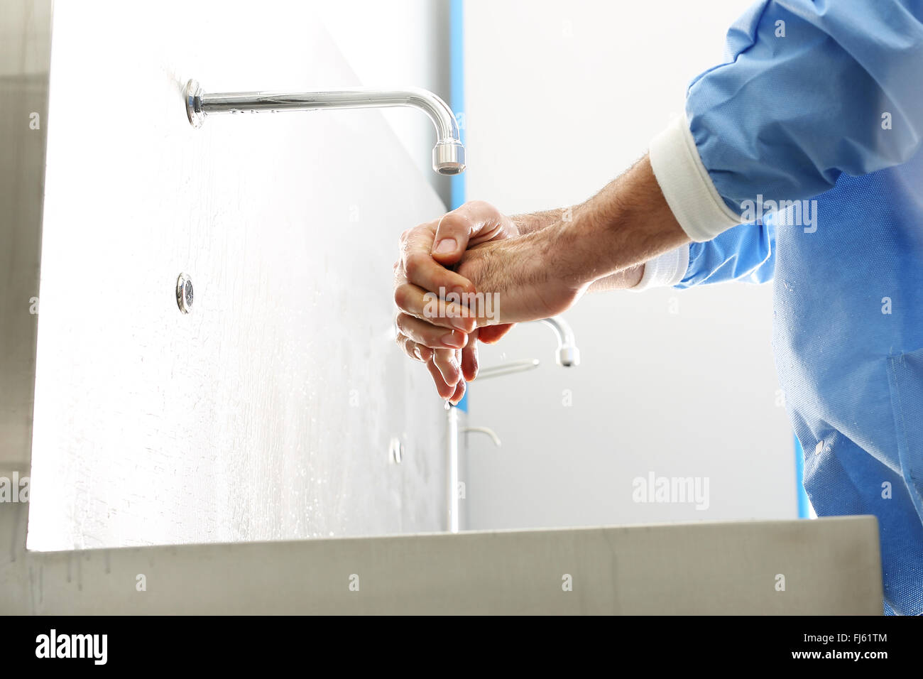 Surgeon washing hands. The doctor washes his hands, disinfect their ...