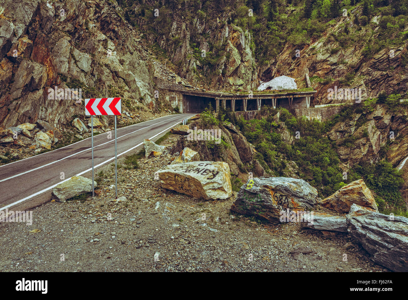 Scenic mountain landscape with roadside triple chevron sign warning for ...