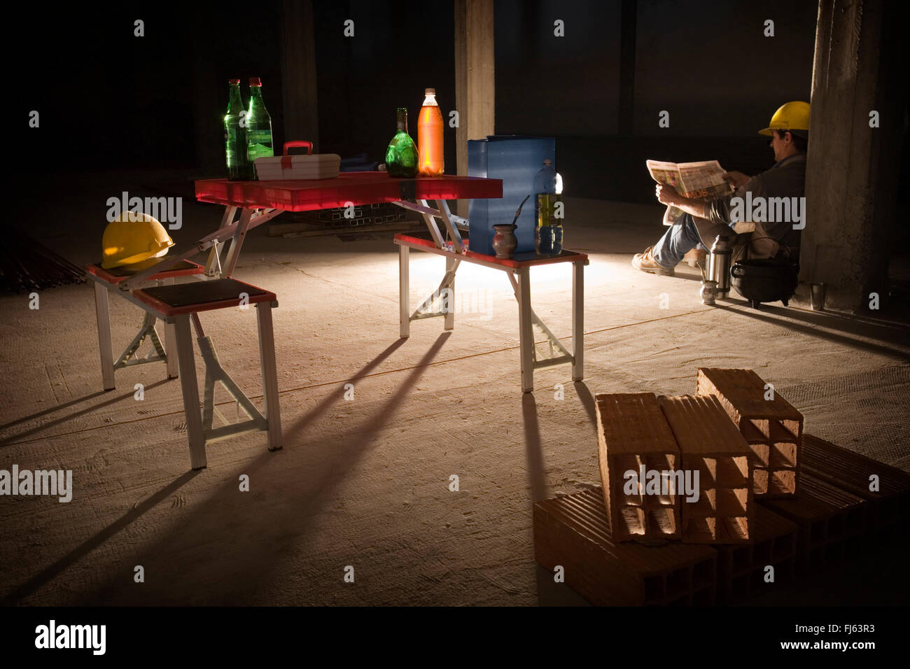 construction worker reading a newspaper in a lunch break, Argentina ...