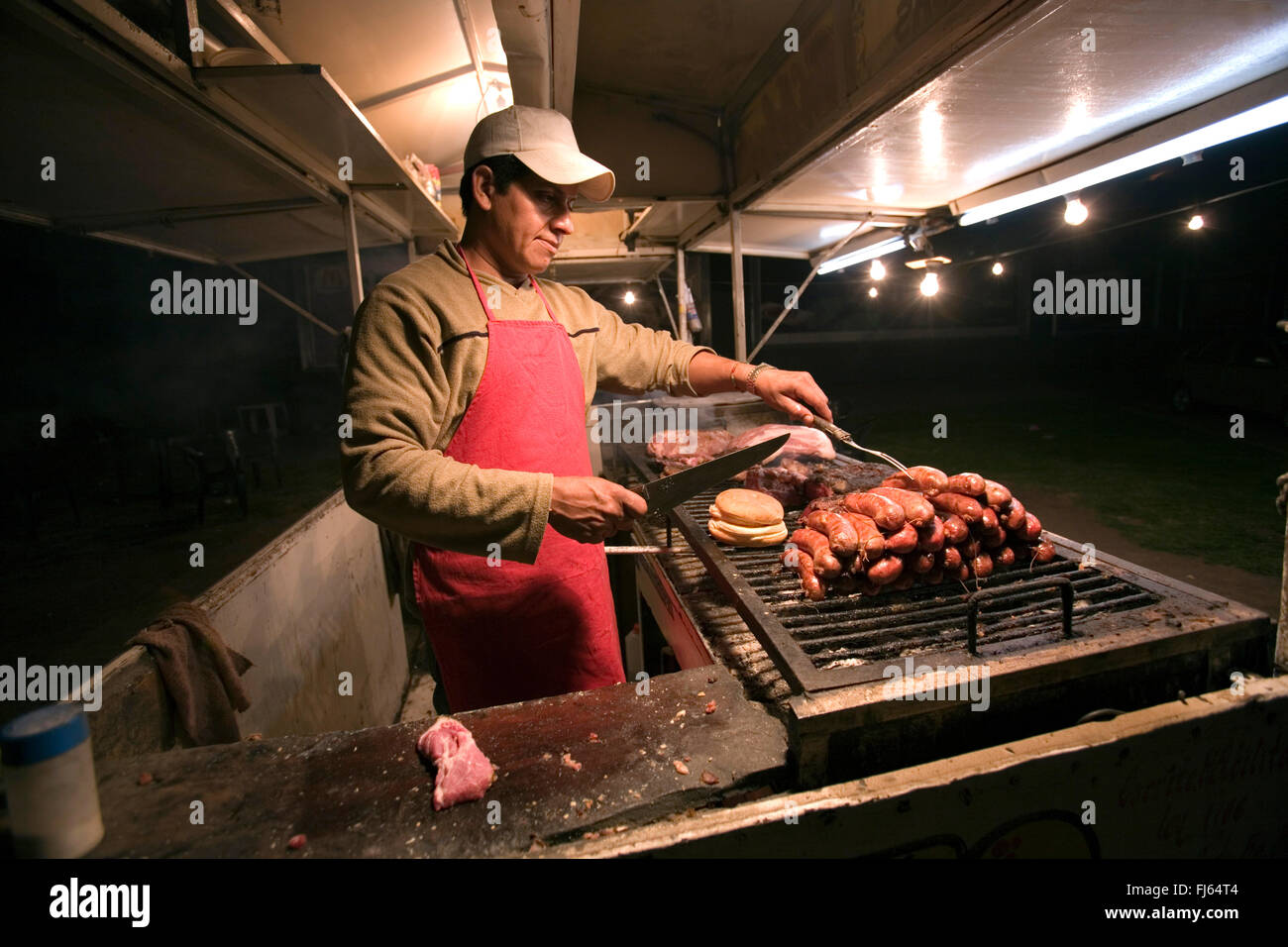 Guy grilling sausages hi-res stock photography and images - Alamy