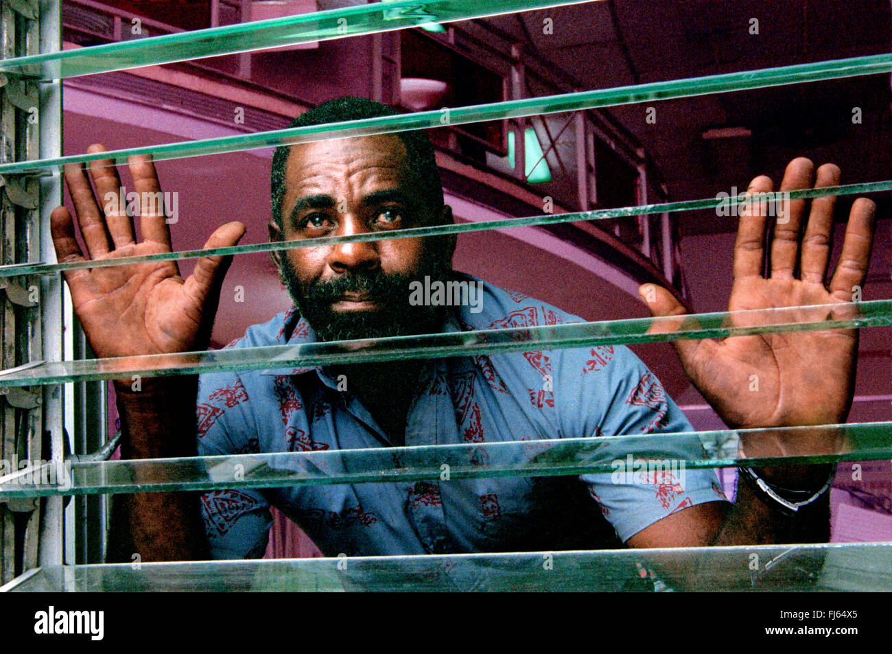 Cuban man behind a window, Cuba Stock Photo - Alamy