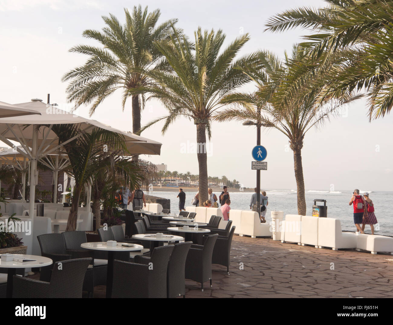 Outdoors seating in a bar on the seaside promenade in Playa las ...