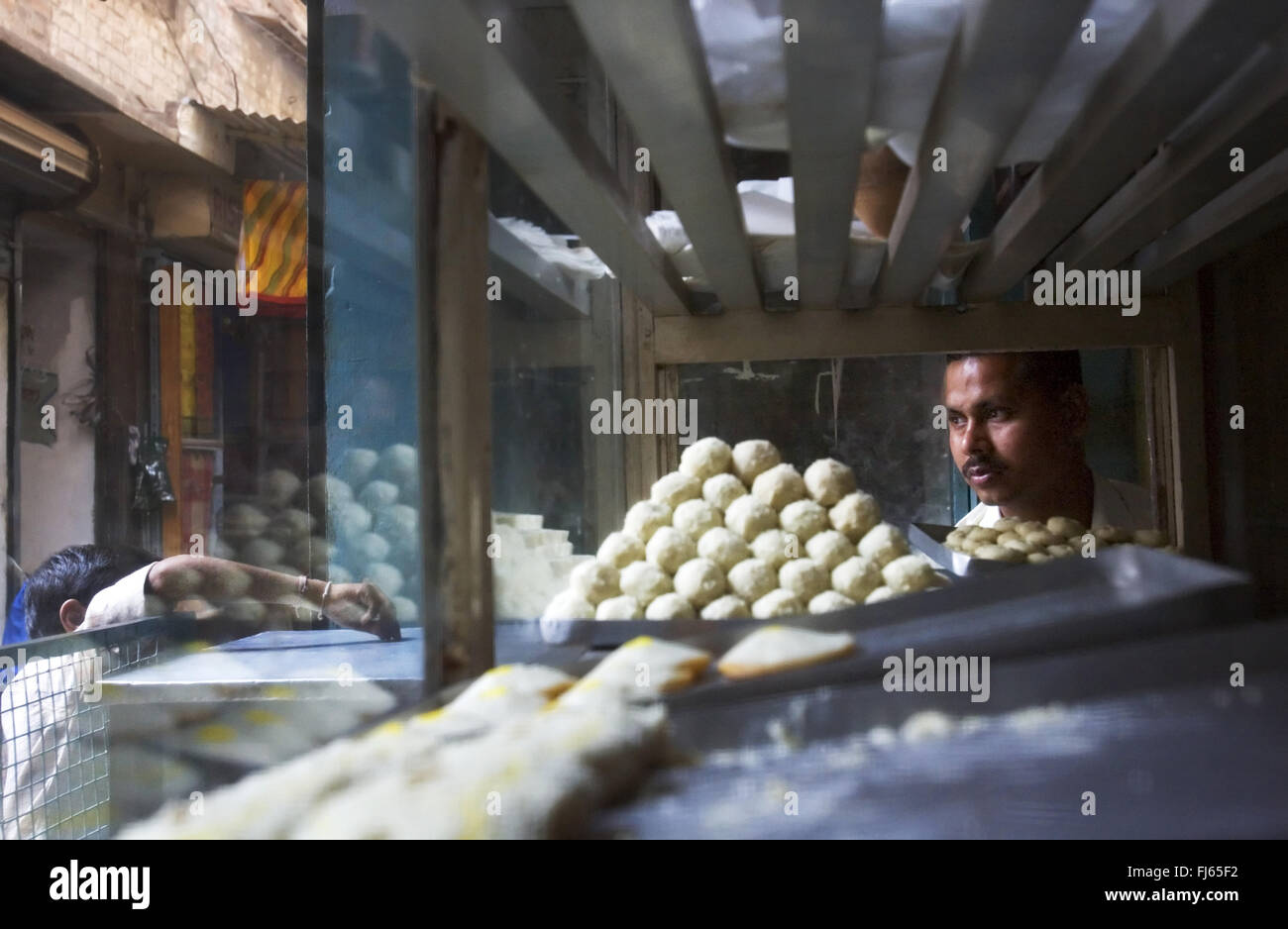 boy buying sweet pastry in a shop, India, Varanasi Stock Photo - Alamy