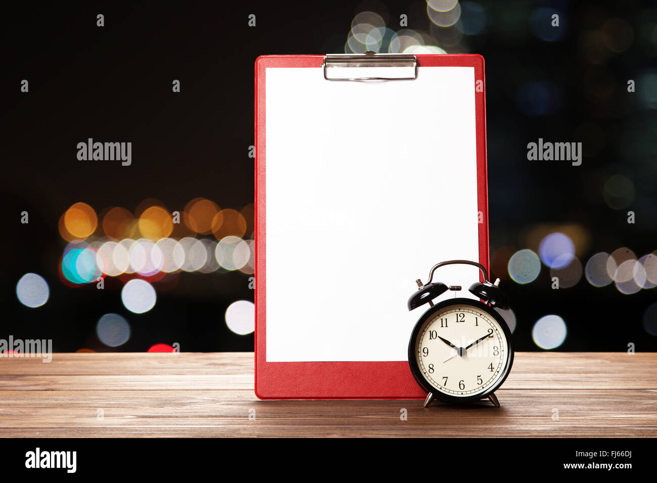 Blank paper sheet and alarm clock Stock Photo - Alamy