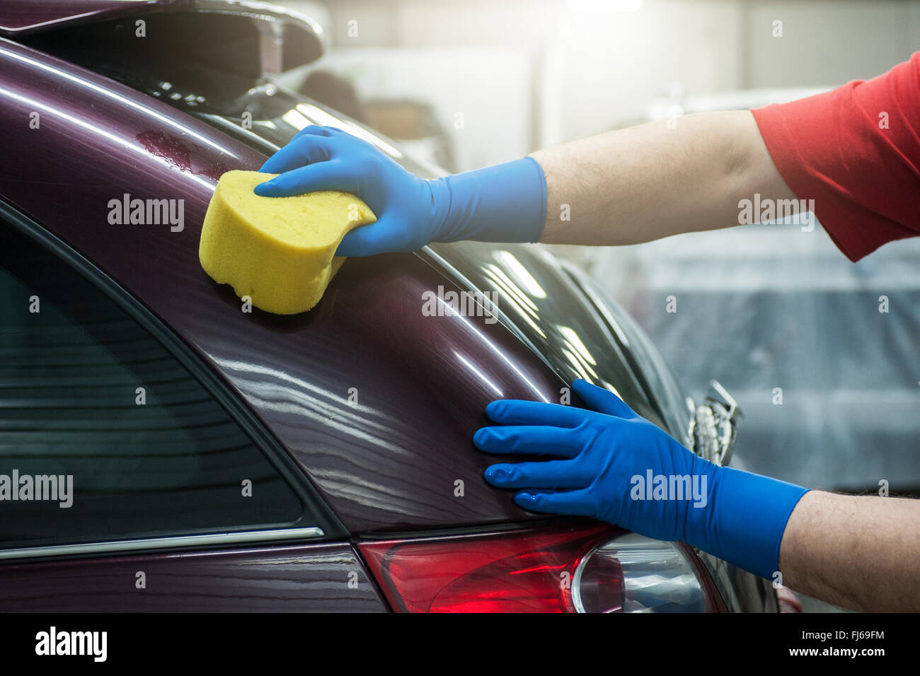 hand with sponge over the car for washing Stock Photo - Alamy
