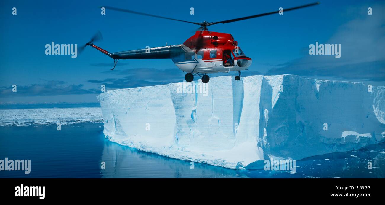 russian MI 2 helicopter flying over table iceberg, Antarctica Stock ...