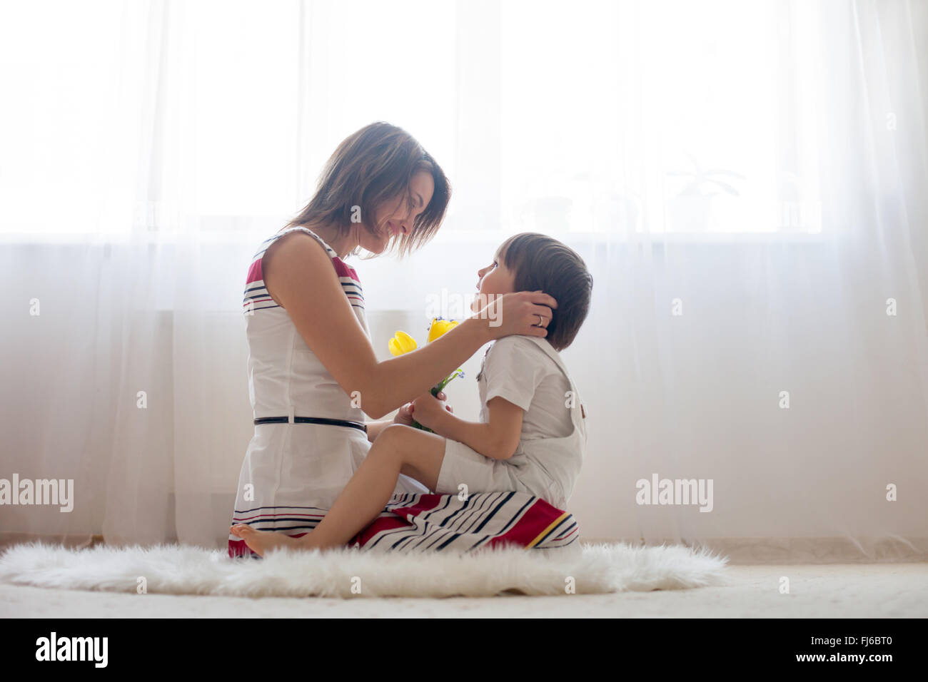Mother and her child, embracing with tenderness and care, child giving ...