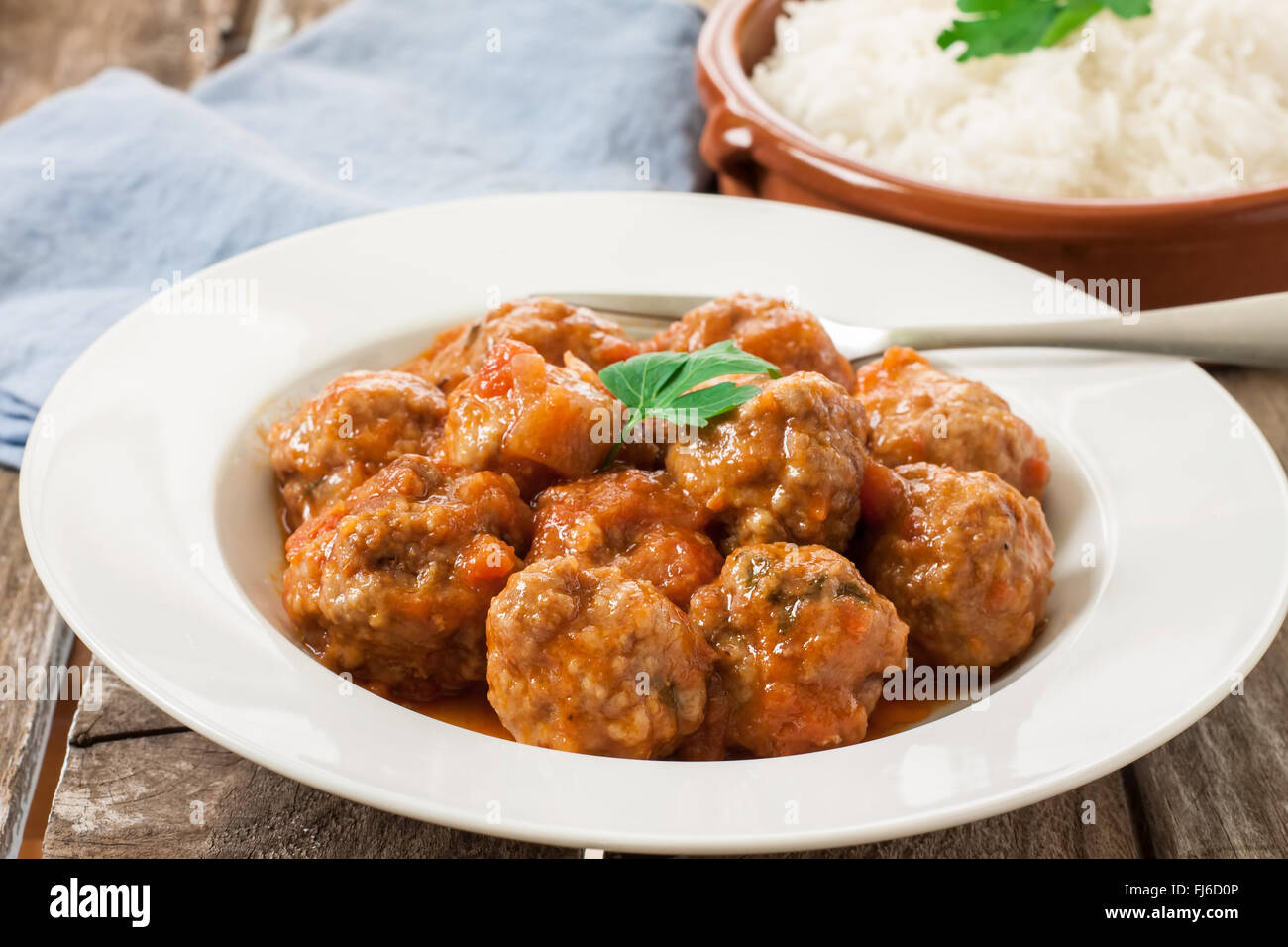 beef meatballs on tomato sauce with rice for side Stock Photo - Alamy