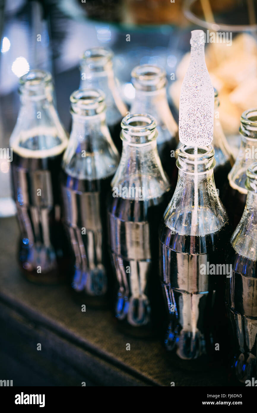 Refreshing Brown Soda in bottles in Candy Bar On Table. Delicious sweet ...
