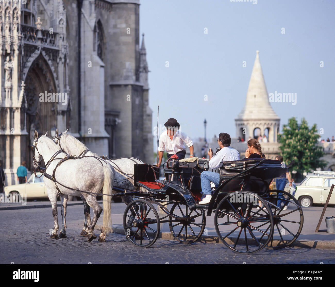Couple riding on horse carriage outside Matthias Church, The Castle ...