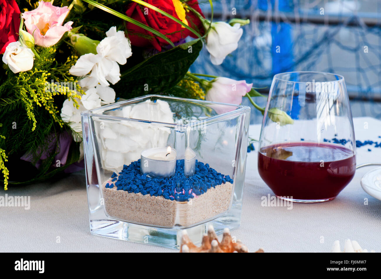 particular table set by the sea with glass of wine and candle Stock ...