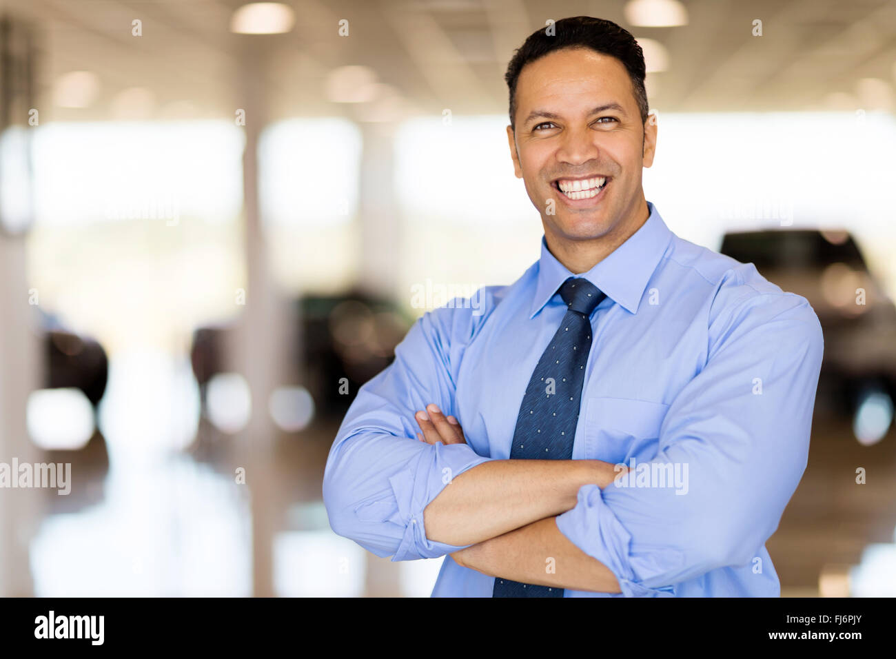 good looking male car dealer principal inside showroom Stock Photo - Alamy