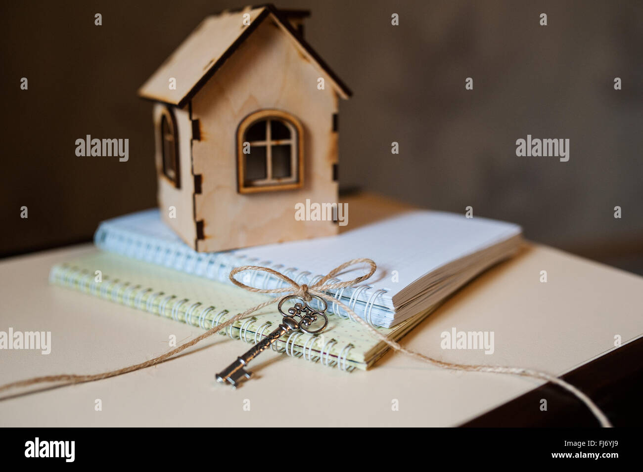 Conceptual image with small wooden house and keys Stock Photo - Alamy