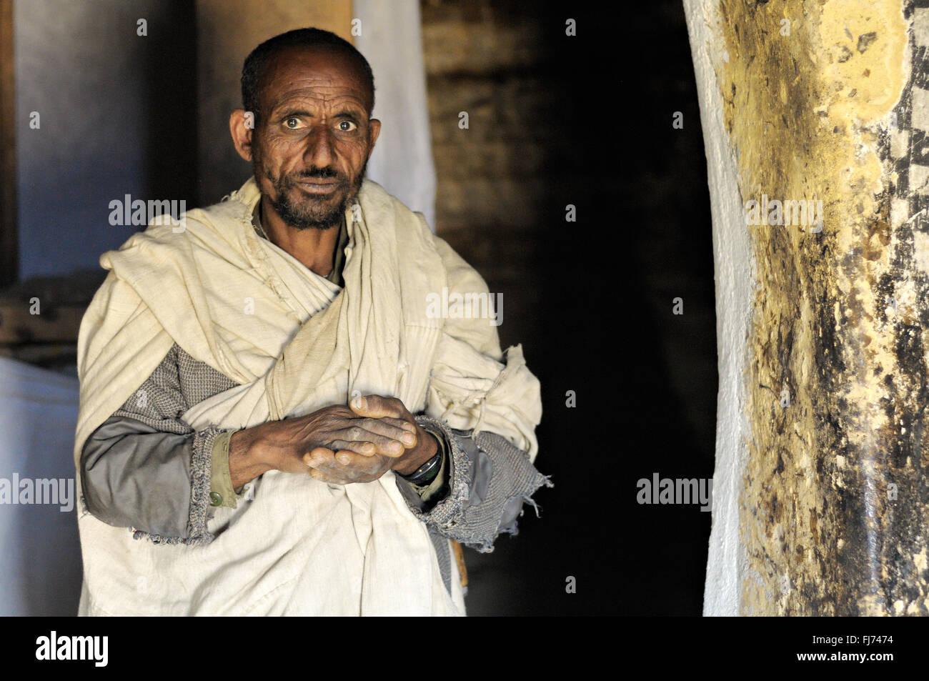 Orthodox priest inside Petros and Paulos rock-hewn church in the Tigray ...