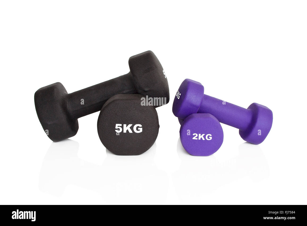 Black 5kg and purple 2kg dumbbells isolated on white background ...