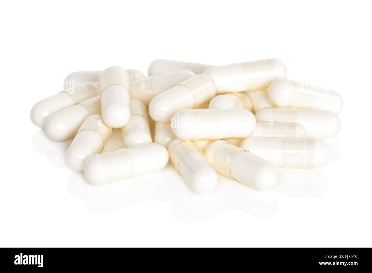A pile of magnesium supplement capsules isolated on a white background ...