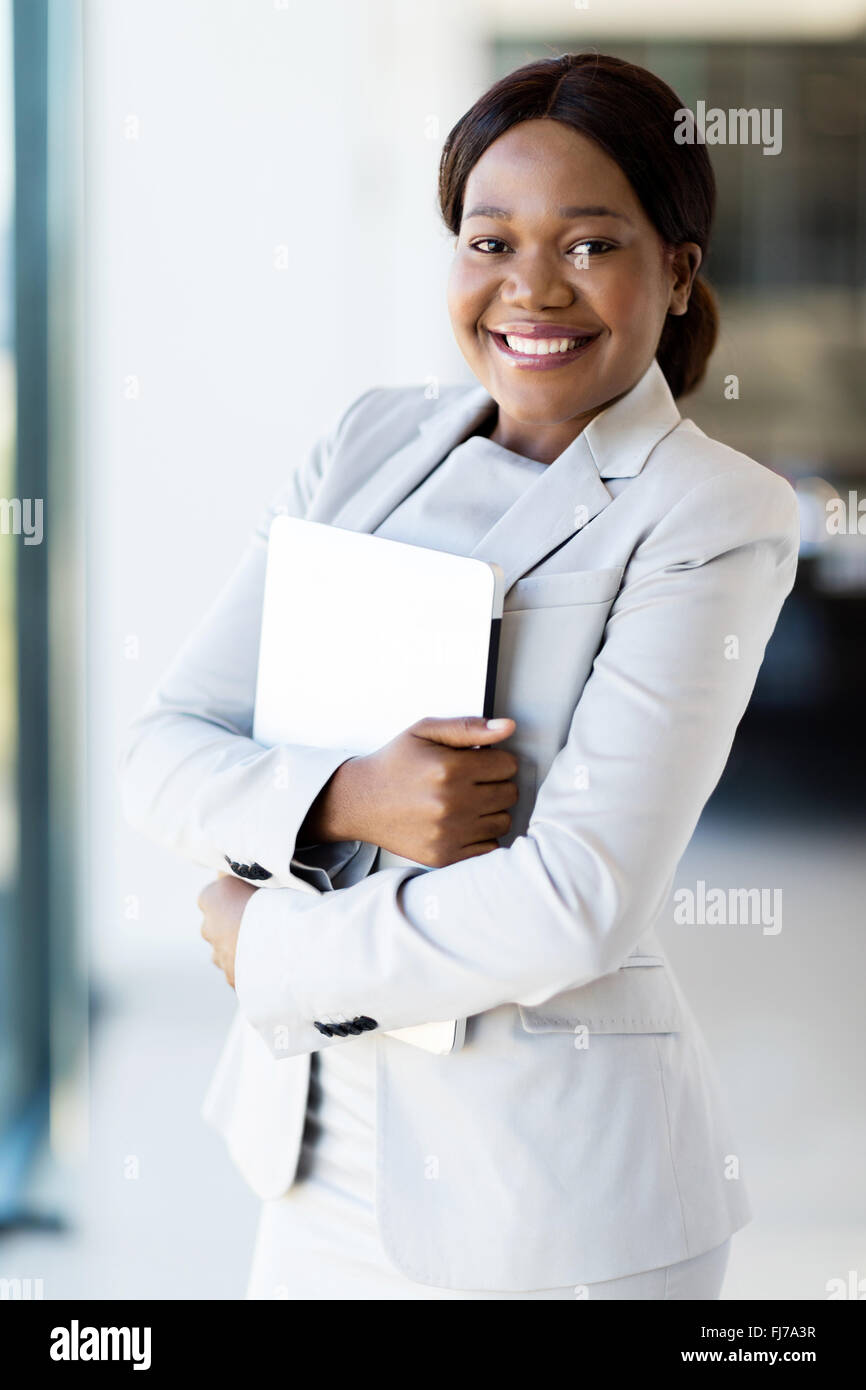 pretty young African office worker holding laptop computer Stock Photo ...