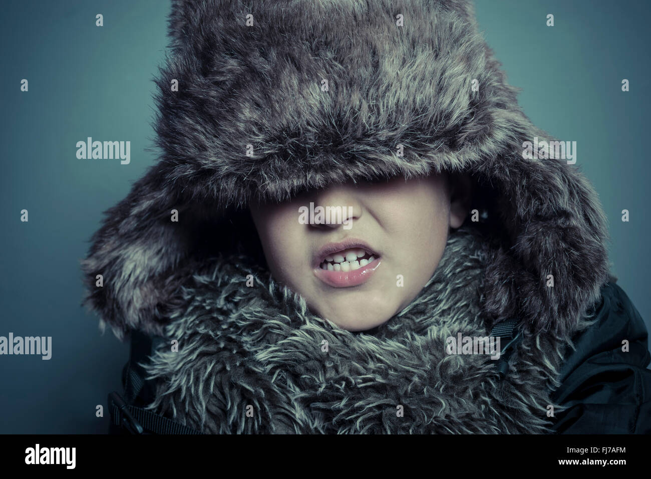 Scarf, Sad child with fur hat and winter coat, cold concept and storm ...