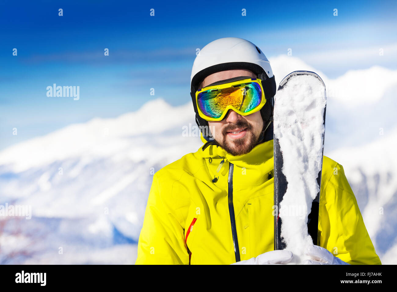 Portrait of man with ski over mountains Stock Photo - Alamy
