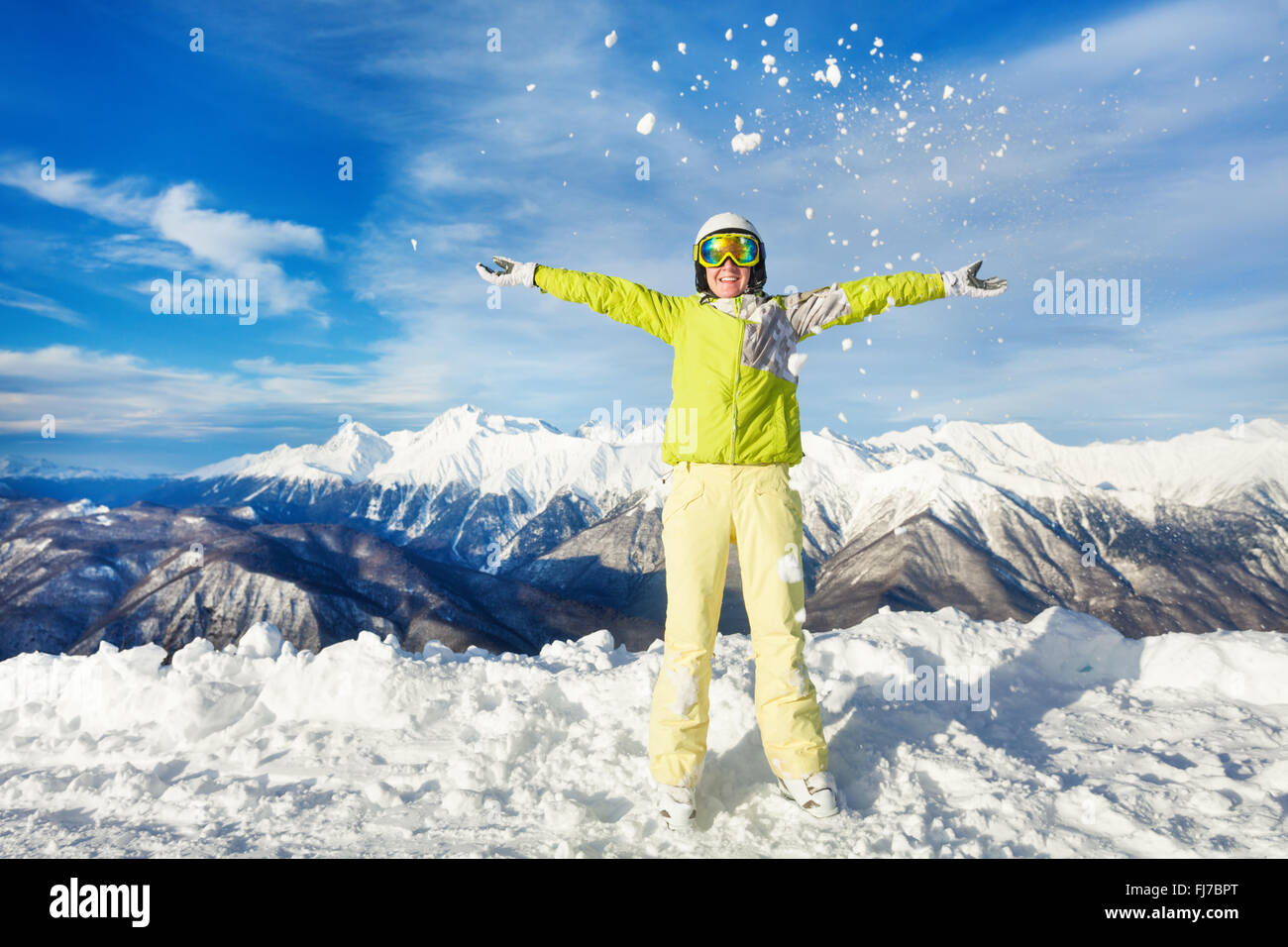 Happy skier woman throwing snow up Stock Photo - Alamy