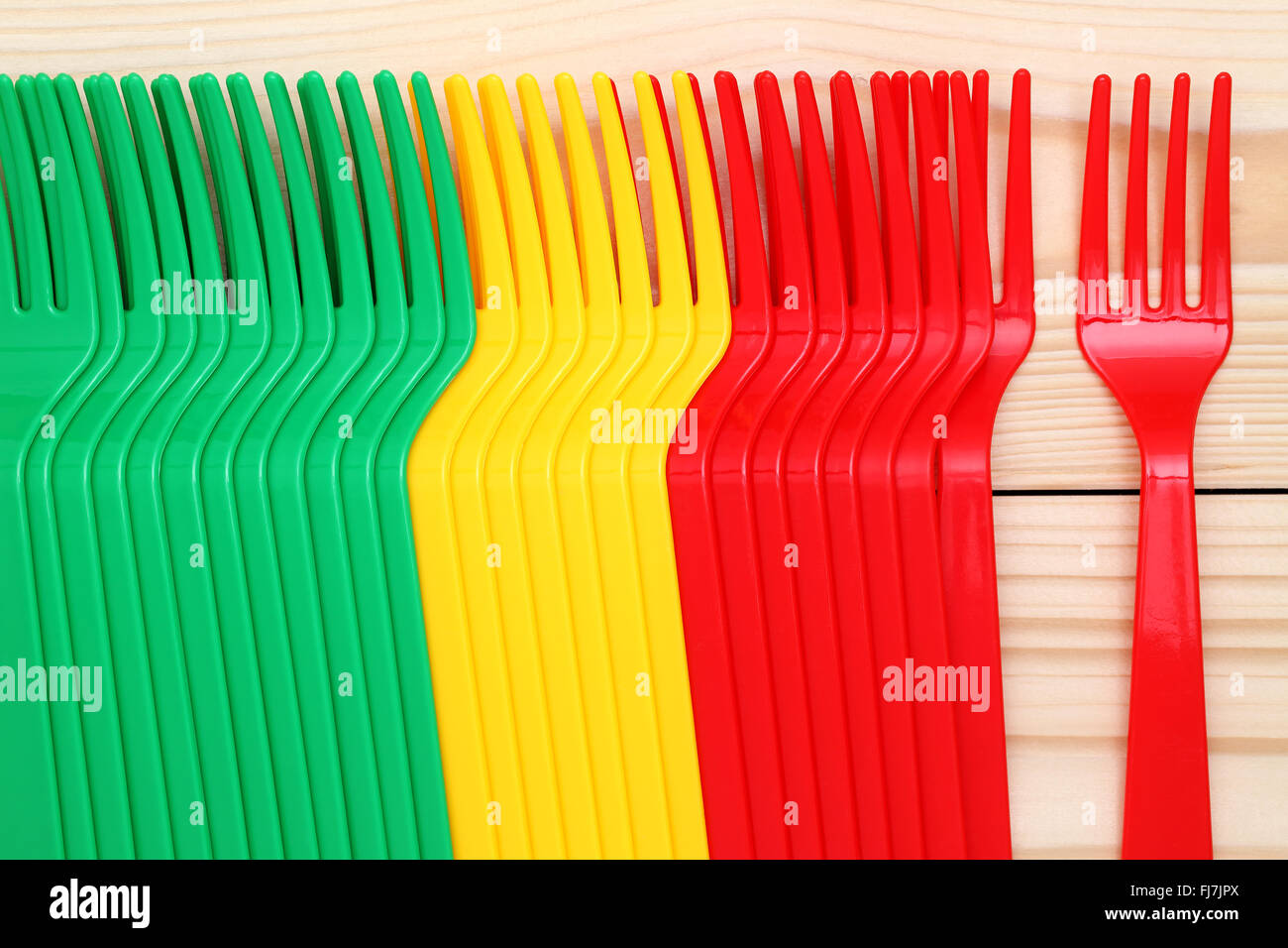 plastic colorful forks on wood background Stock Photo - Alamy