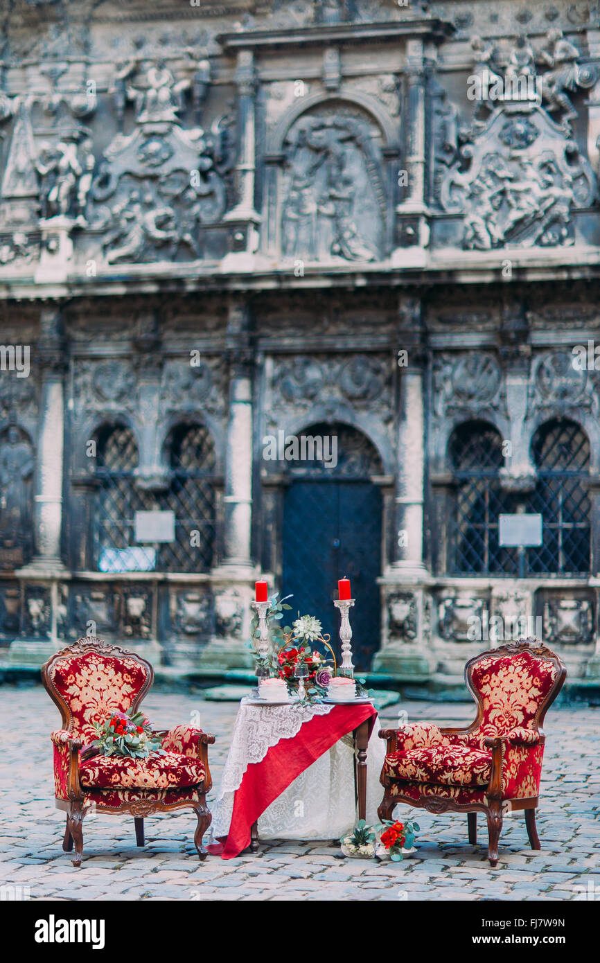 Vintage skillfully setted wedding table with luxury red armchairs ...
