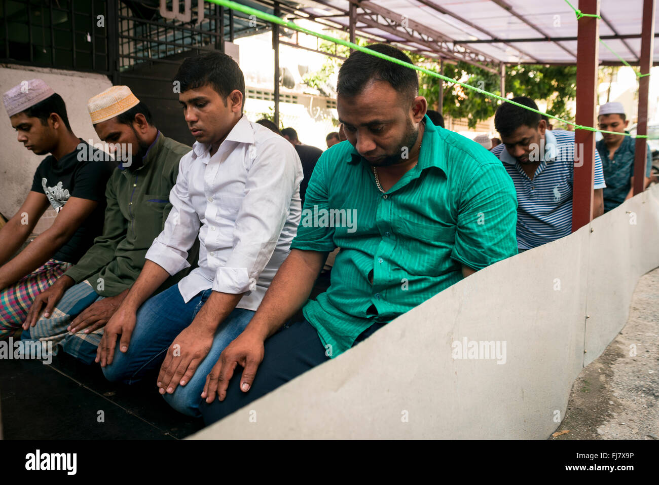 Kuala Lumpur, Malaysia - February 7, 2016. Muslim people praying in a ...