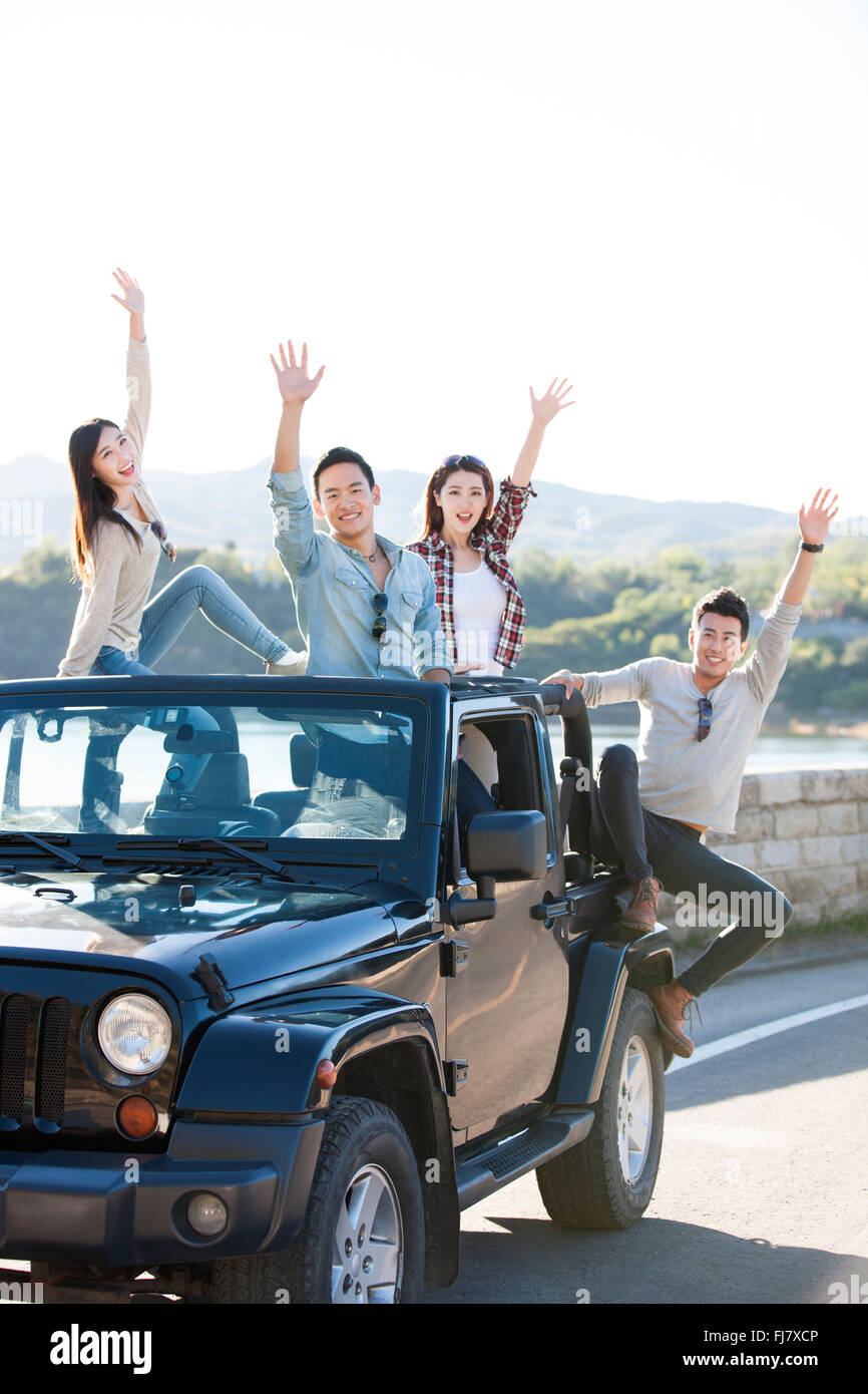 Chinese friends having fun in a jeep Stock Photo - Alamy