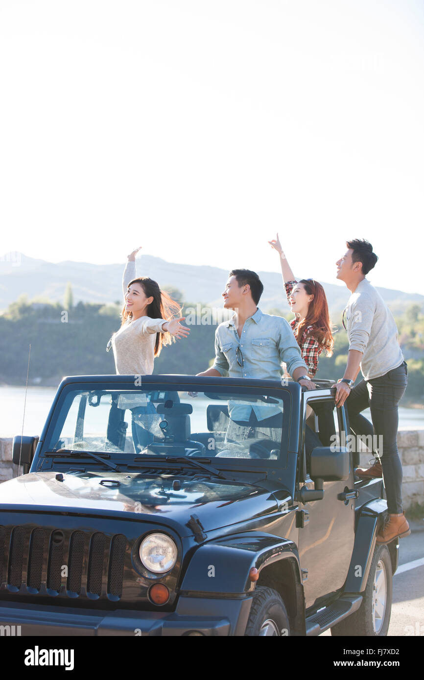 Chinese friends having fun in a jeep Stock Photo - Alamy