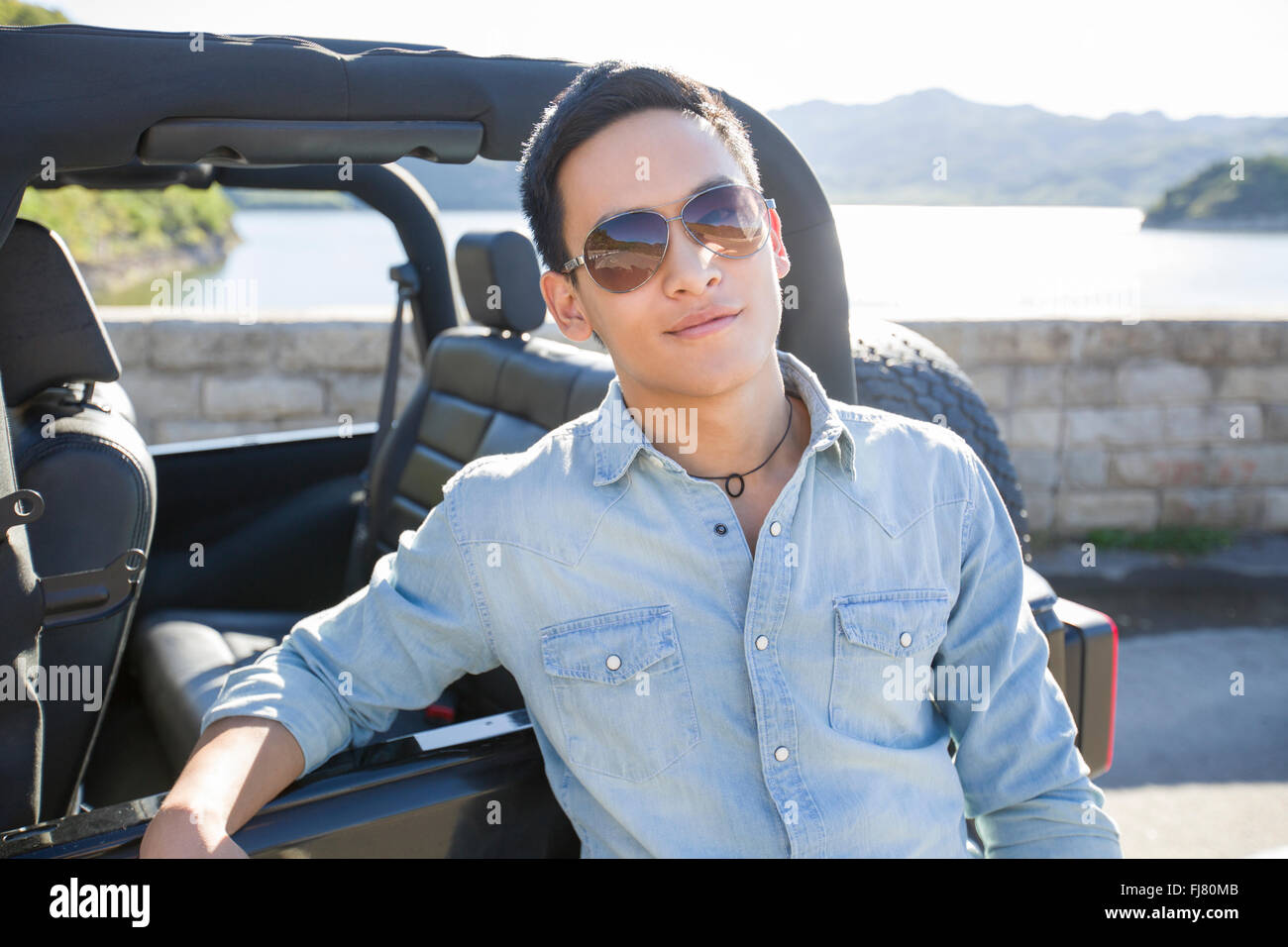 Young Chinese man and jeep Stock Photo - Alamy