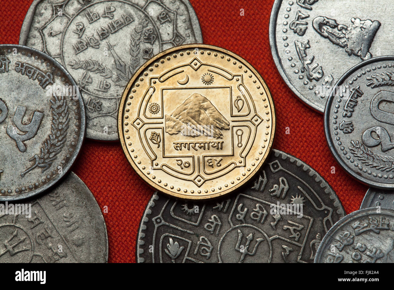 Coins of Nepal. Mount Everest (Sagarmatha) depicted in the Nepalese one ...