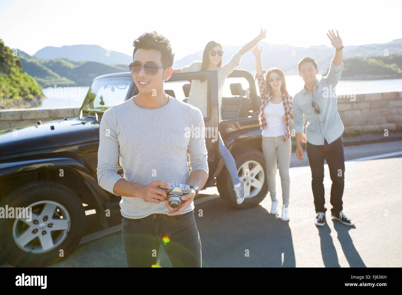 Happy Chinese friends and jeep Stock Photo - Alamy