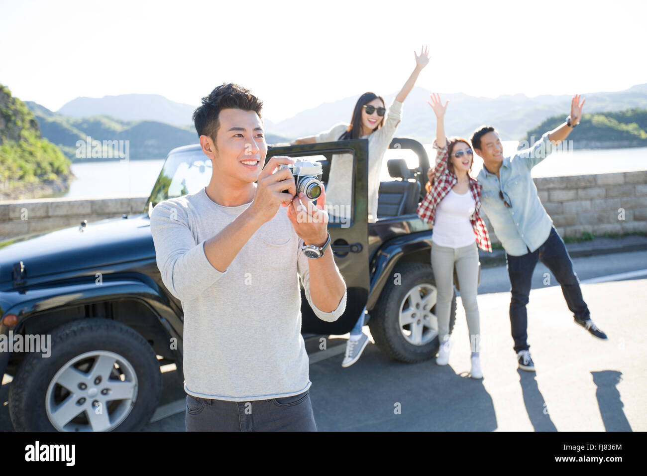 Happy Chinese friends and jeep Stock Photo - Alamy