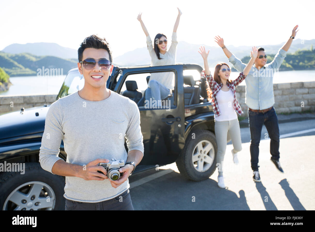 Happy Chinese friends and jeep Stock Photo - Alamy