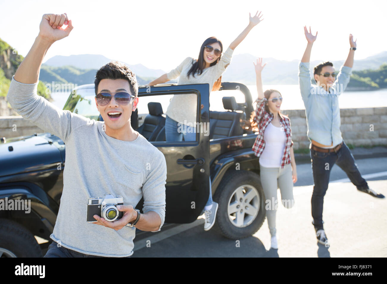 Happy Chinese friends and jeep Stock Photo - Alamy