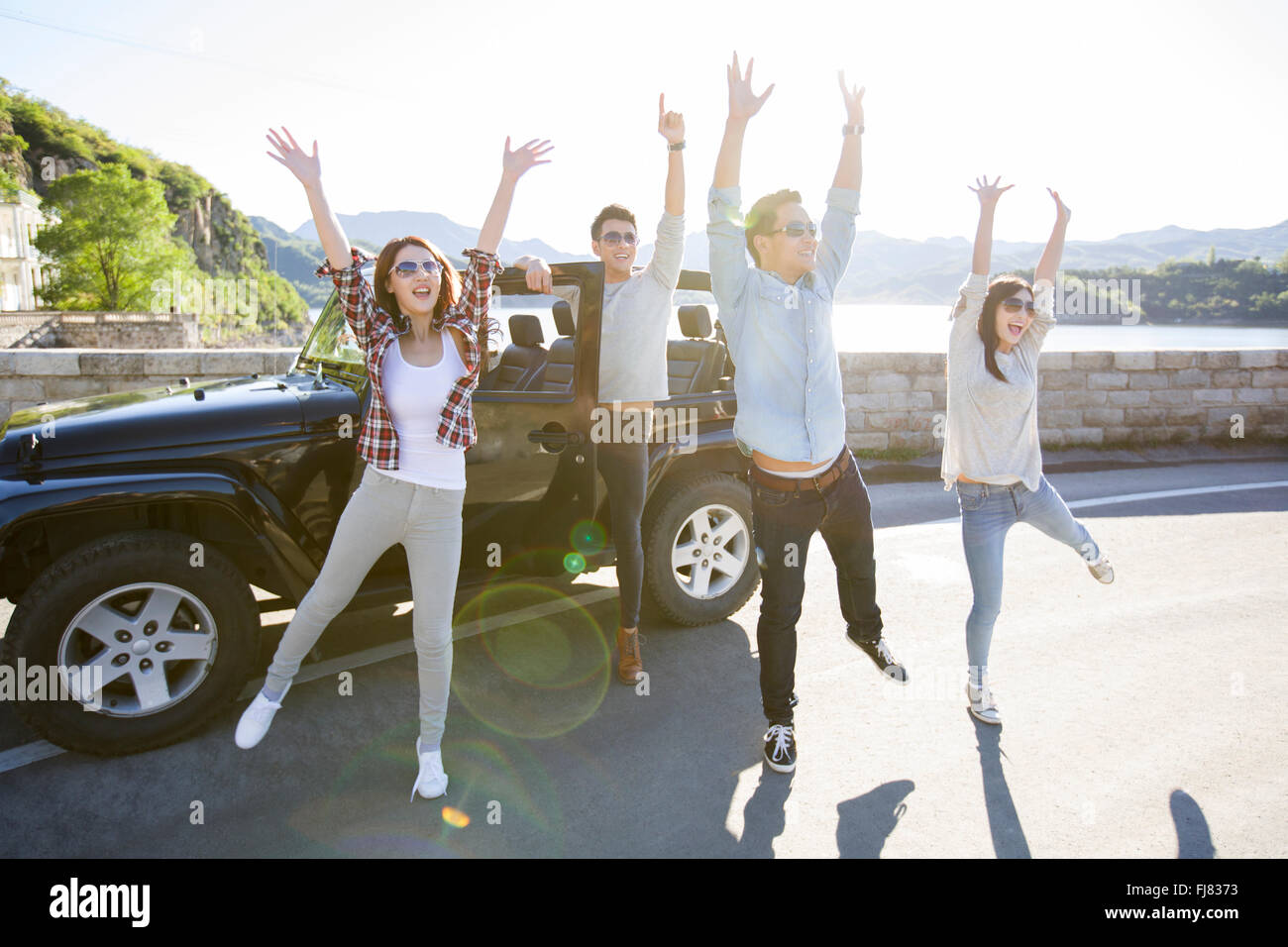 Happy Chinese friends and jeep Stock Photo - Alamy
