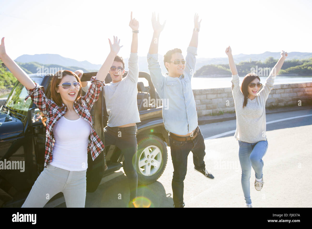Happy Chinese friends and jeep Stock Photo - Alamy