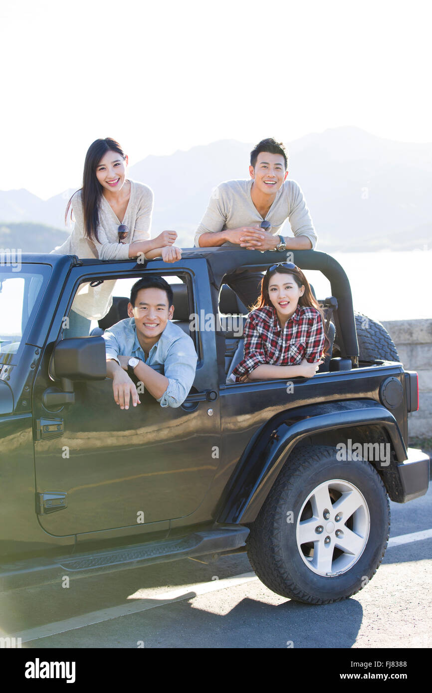 Chinese friends having fun in a jeep Stock Photo - Alamy