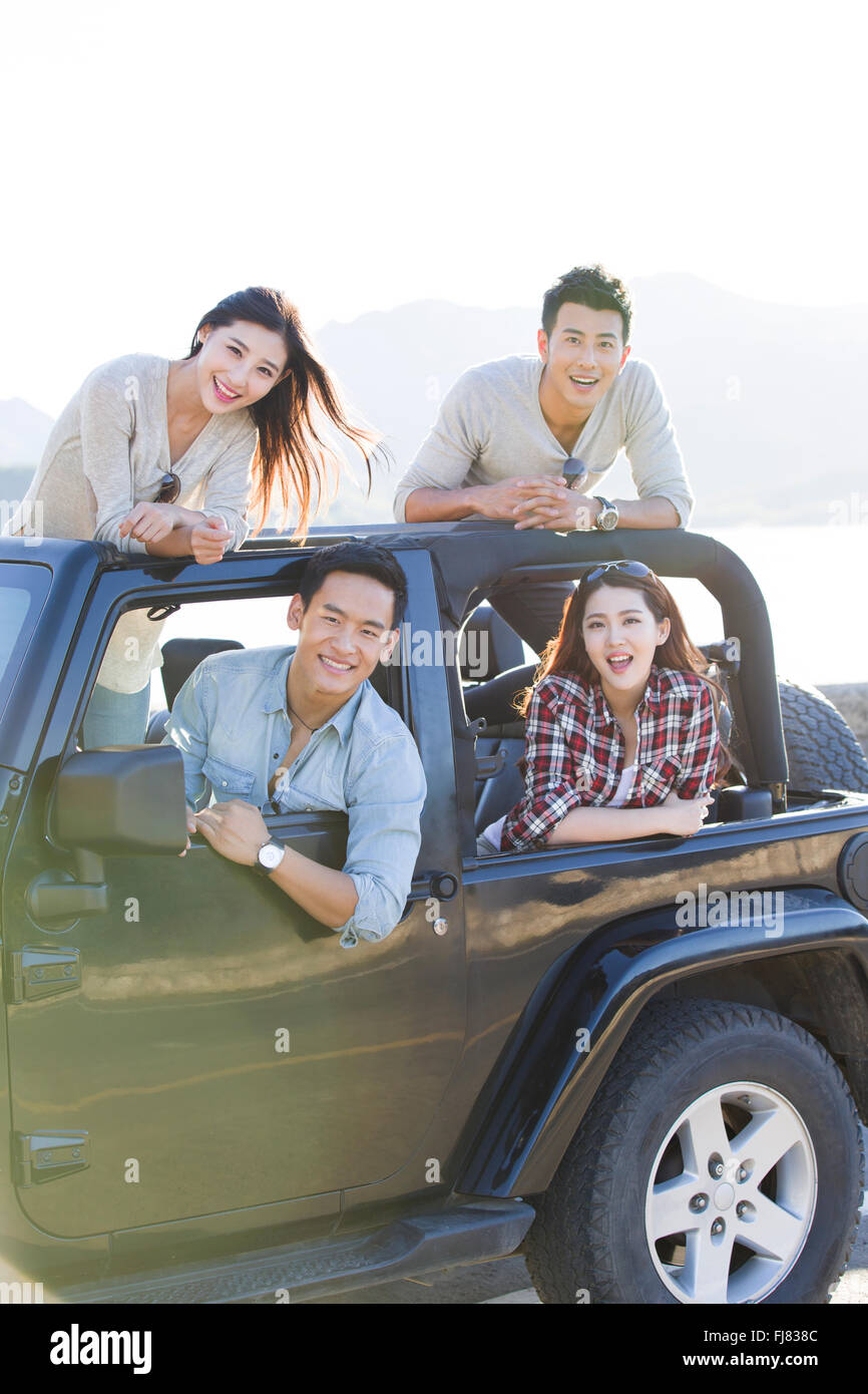 Chinese friends having fun in a jeep Stock Photo - Alamy