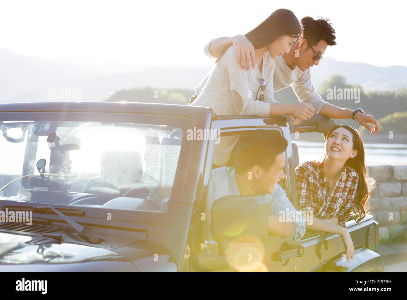 Chinese friends having fun in a jeep Stock Photo - Alamy